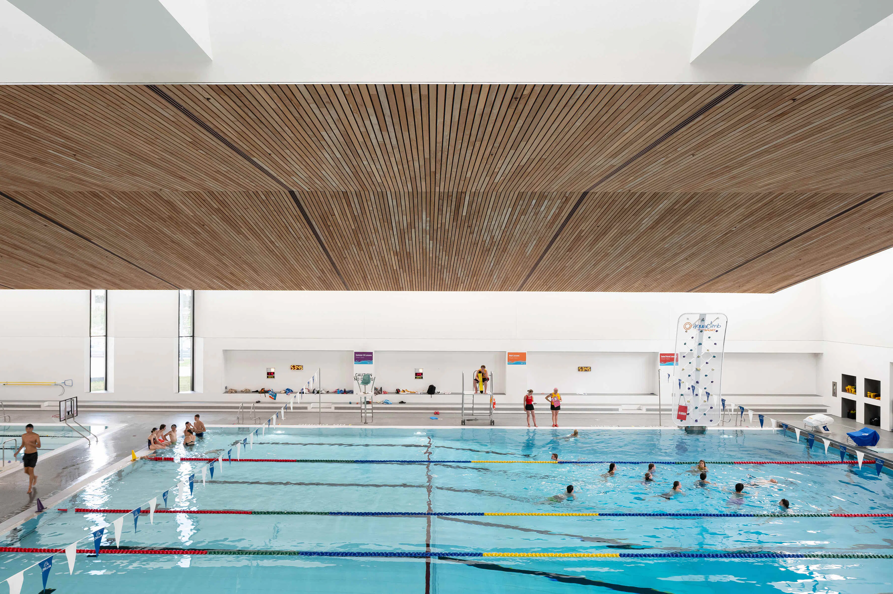A view of a competition-style swimming pool with lane markers, a ...