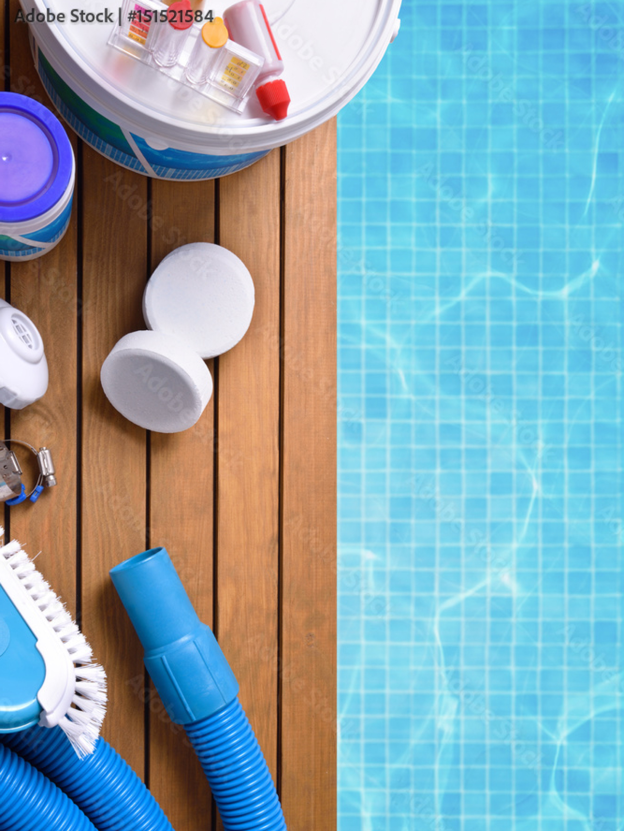 Close-up of pool maintenance chemicals on a wooden deck by a pool