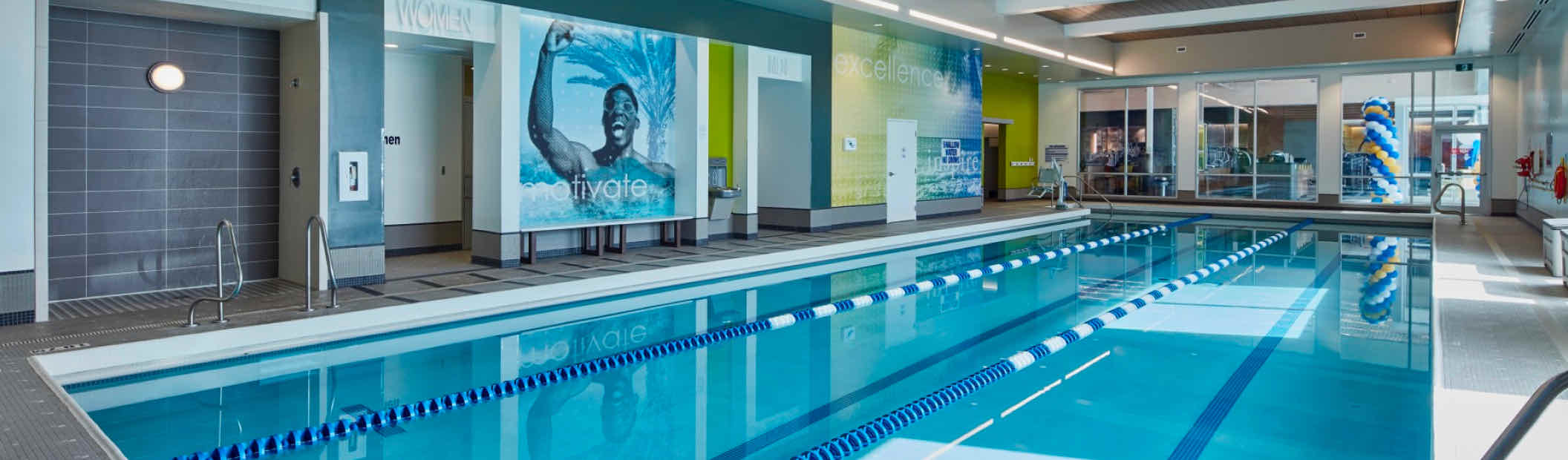 An indoor swimming pool with lane dividers, surrounded by colourful ...