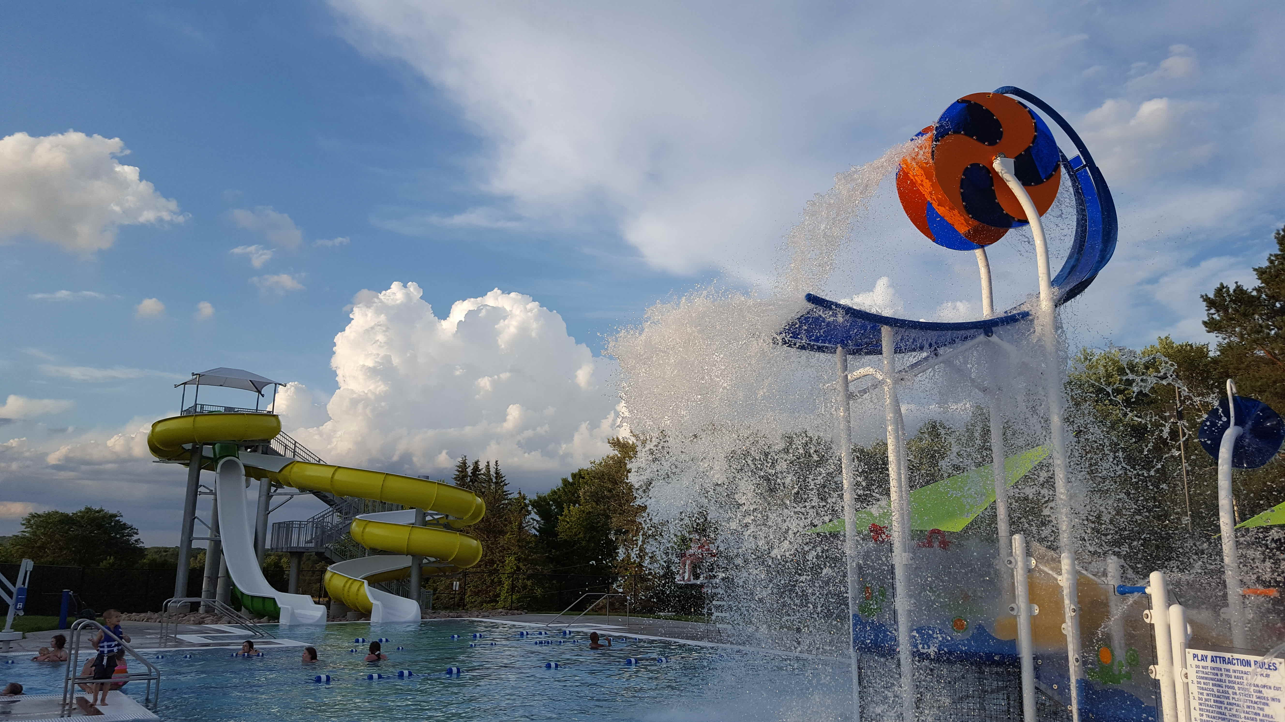 Close-up of a water splash feature in a pool, with a vibrant blue and ...