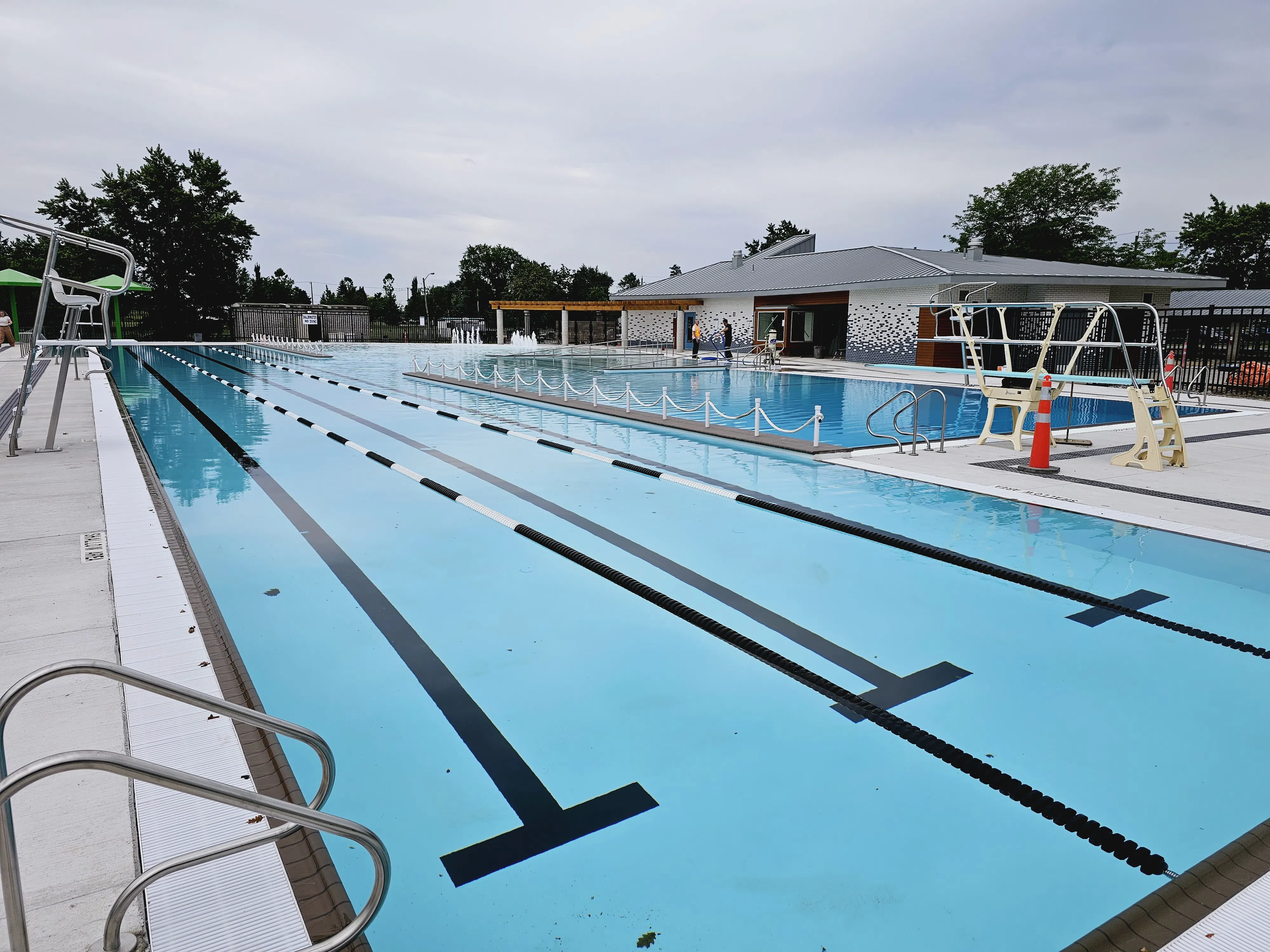 An outdoor pool with a lap pool and a leisure pool in the distance.