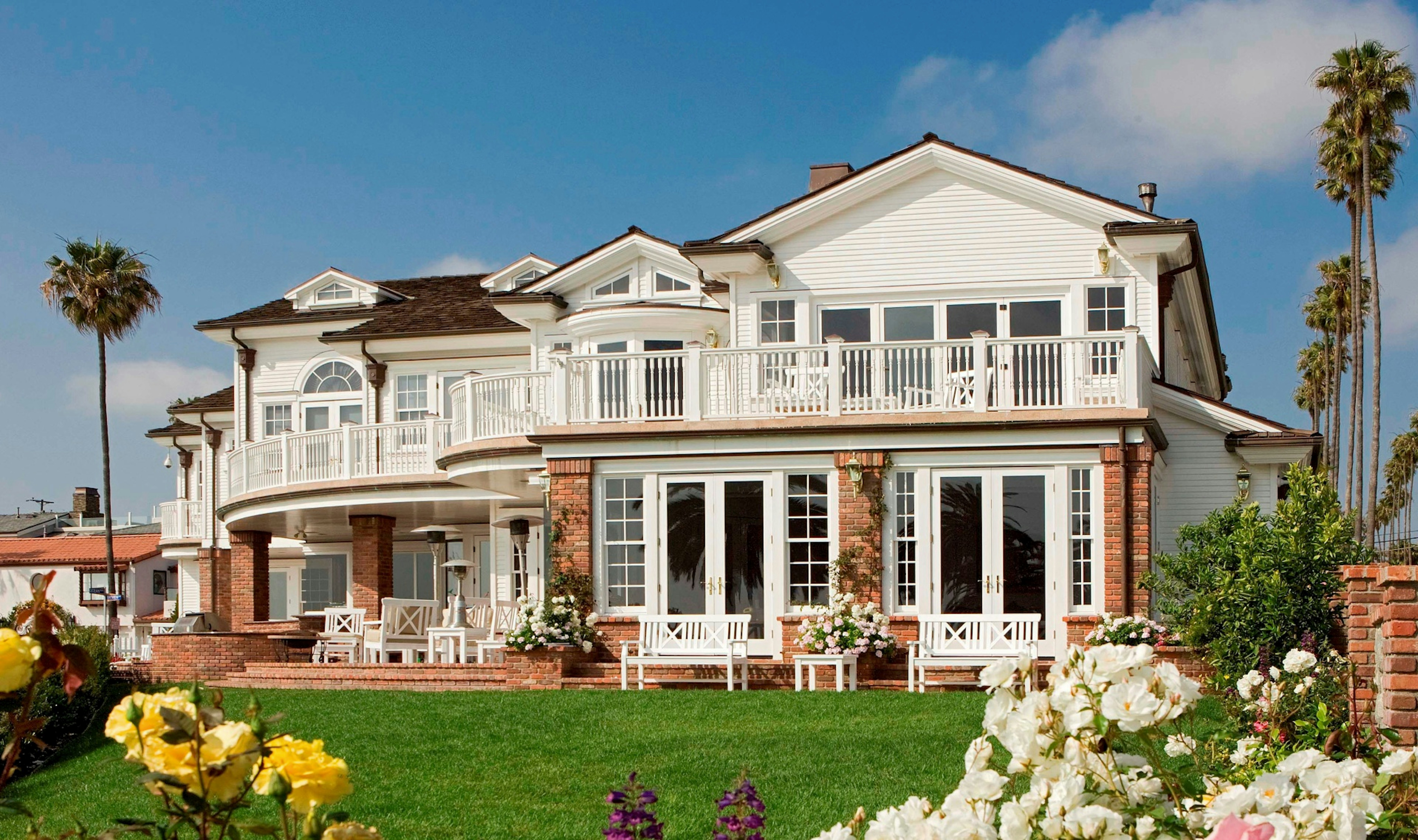 Traditional estate with wood siding and brick on prime coastal property ...