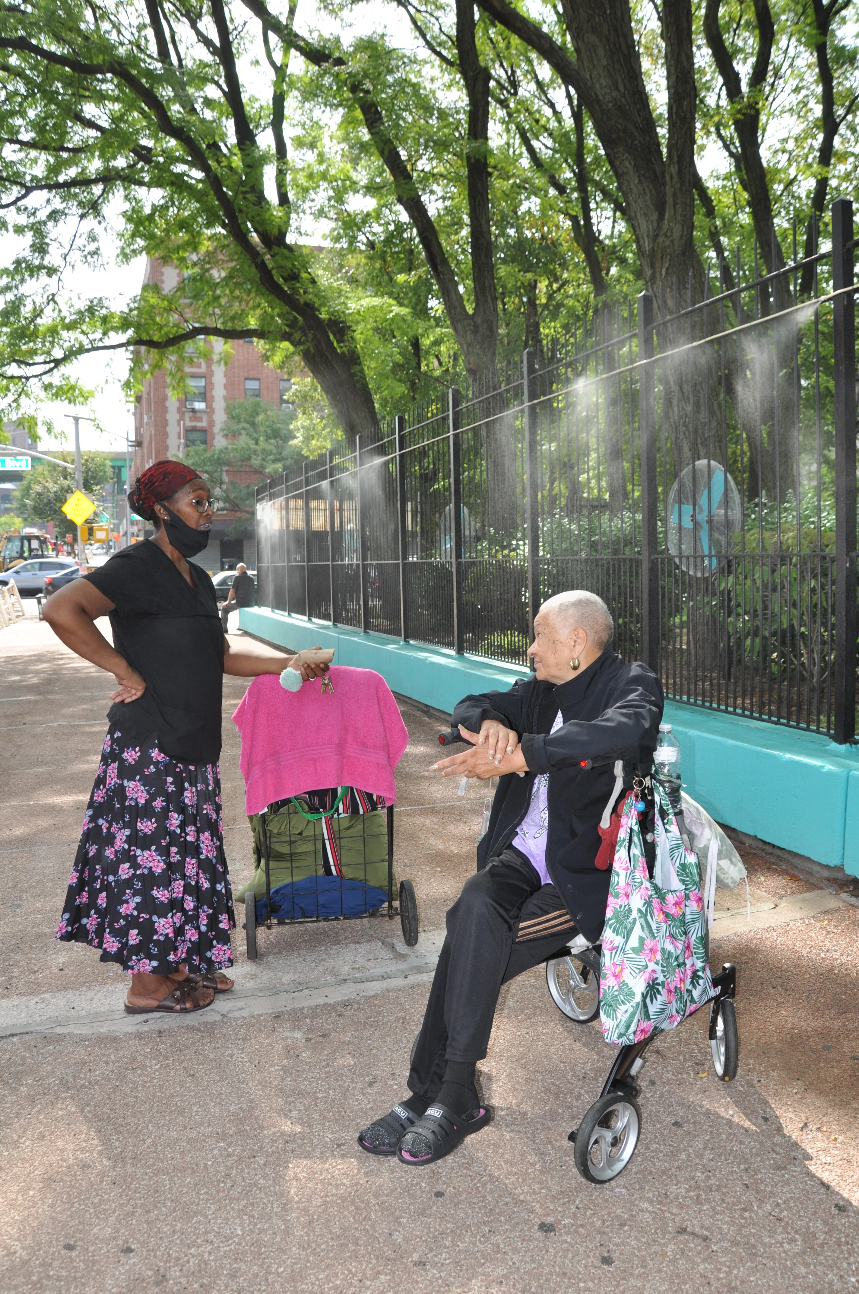 Two South Bronx residents have a lively conversation under the ...