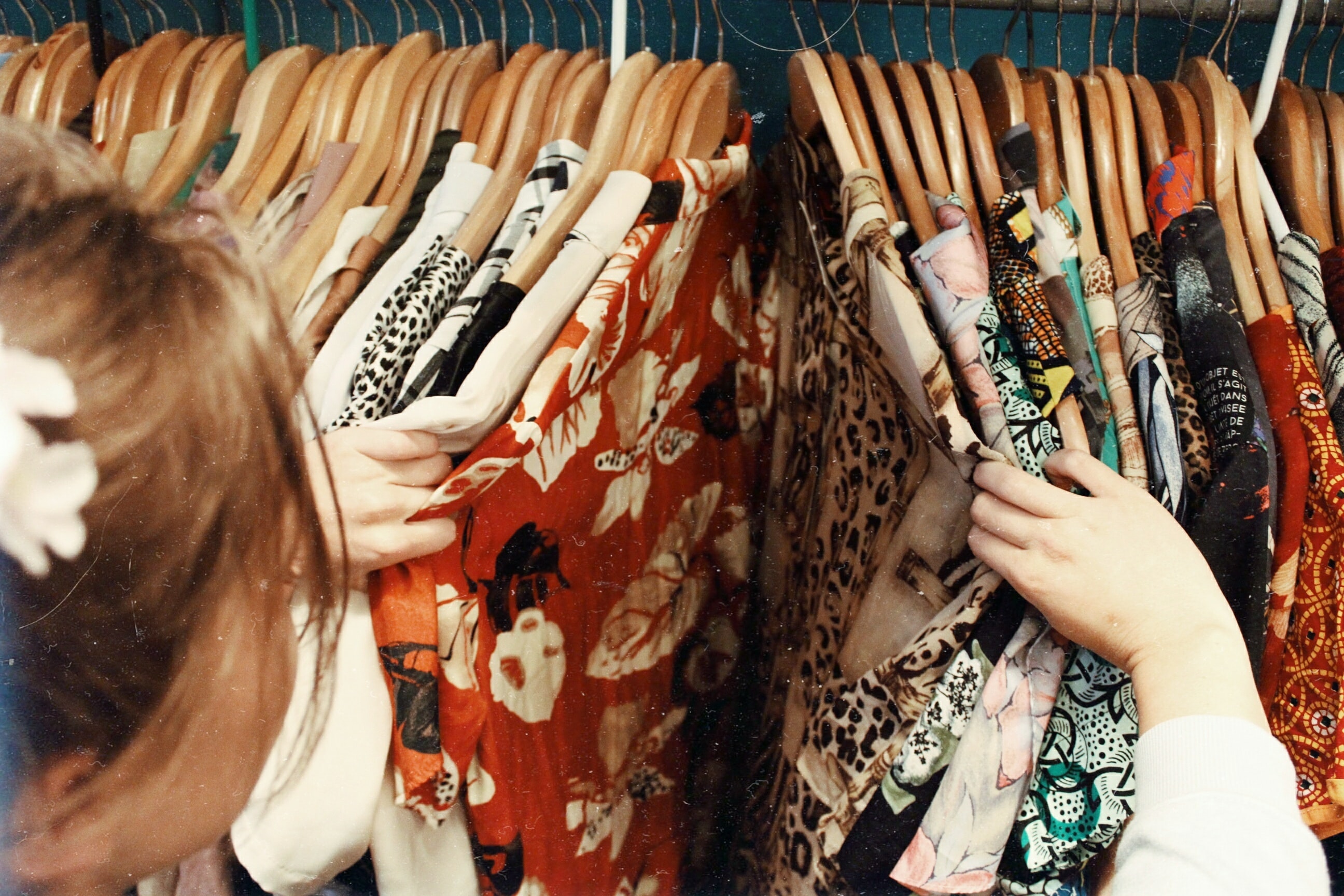 Woman browsing clothes in a vintage boutique.