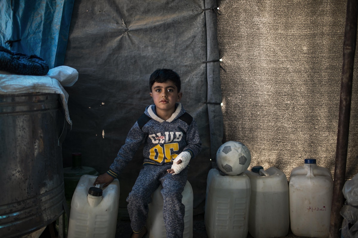 Hidden explosives | 5-year-old Hussein sits on a water container at his ...